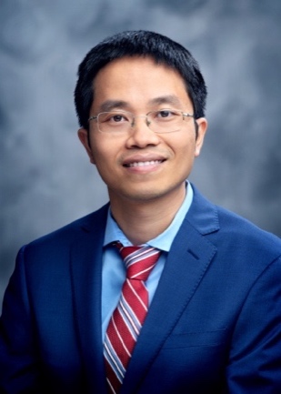 A person in a suit and tieDescription automatically generated